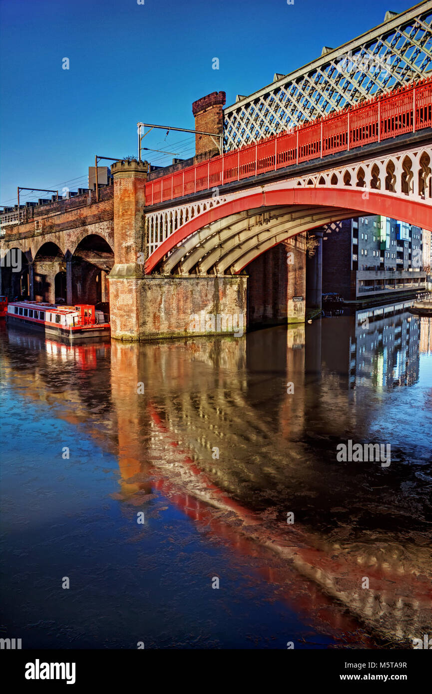Portrait of a Castlefield bridge, with the canal water flowing under ...