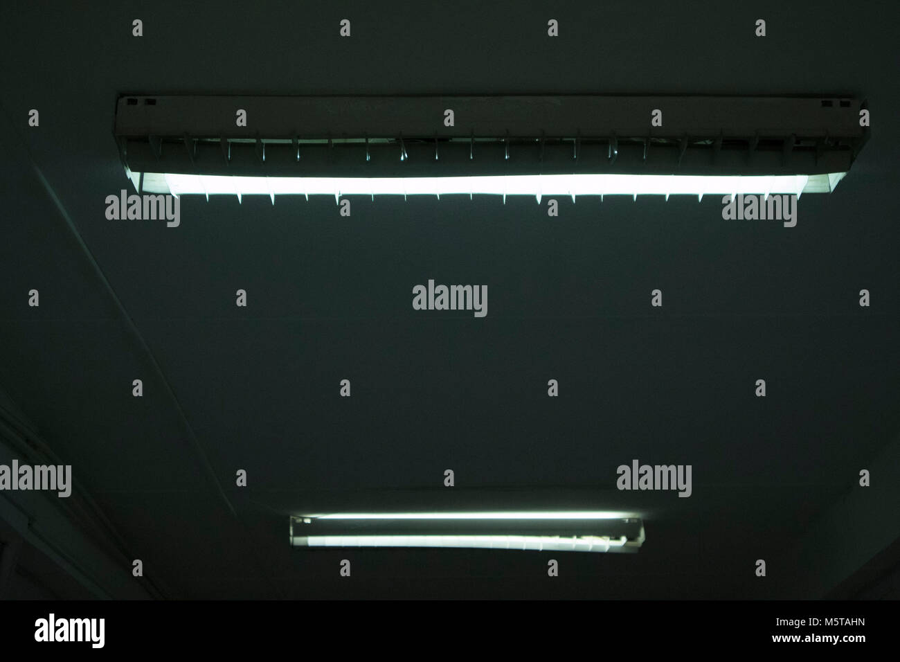 Fluorescent lamps light in a dark corridor Stock Photo - Alamy