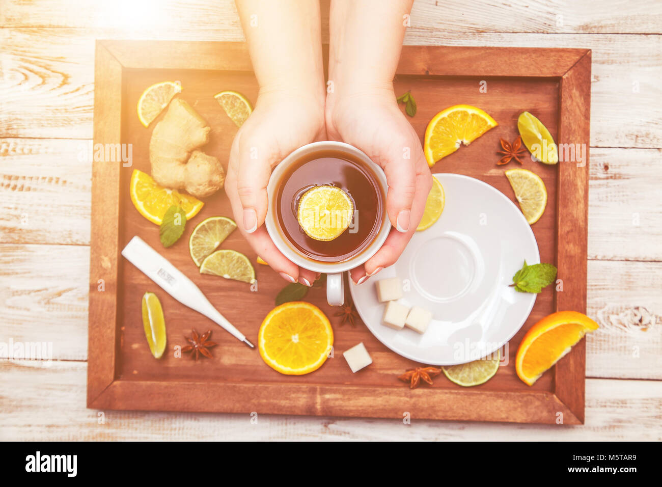 Natural treatments for colds and flu: tea with lemon, ginger, citrus ...