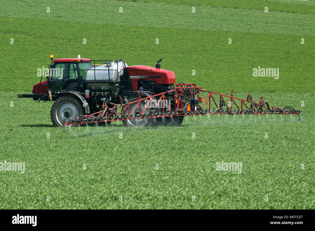 Tractor with agricultural sprayer machine for pesticide spraying Stock ...