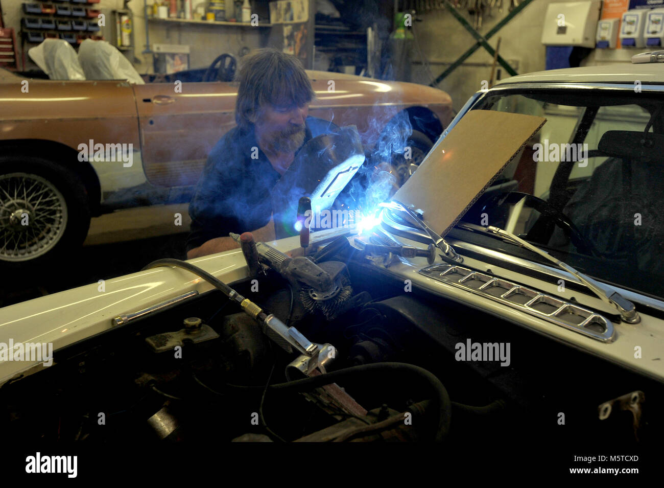 Welding a classic MGB sports car in a workshop Stock Photo - Alamy