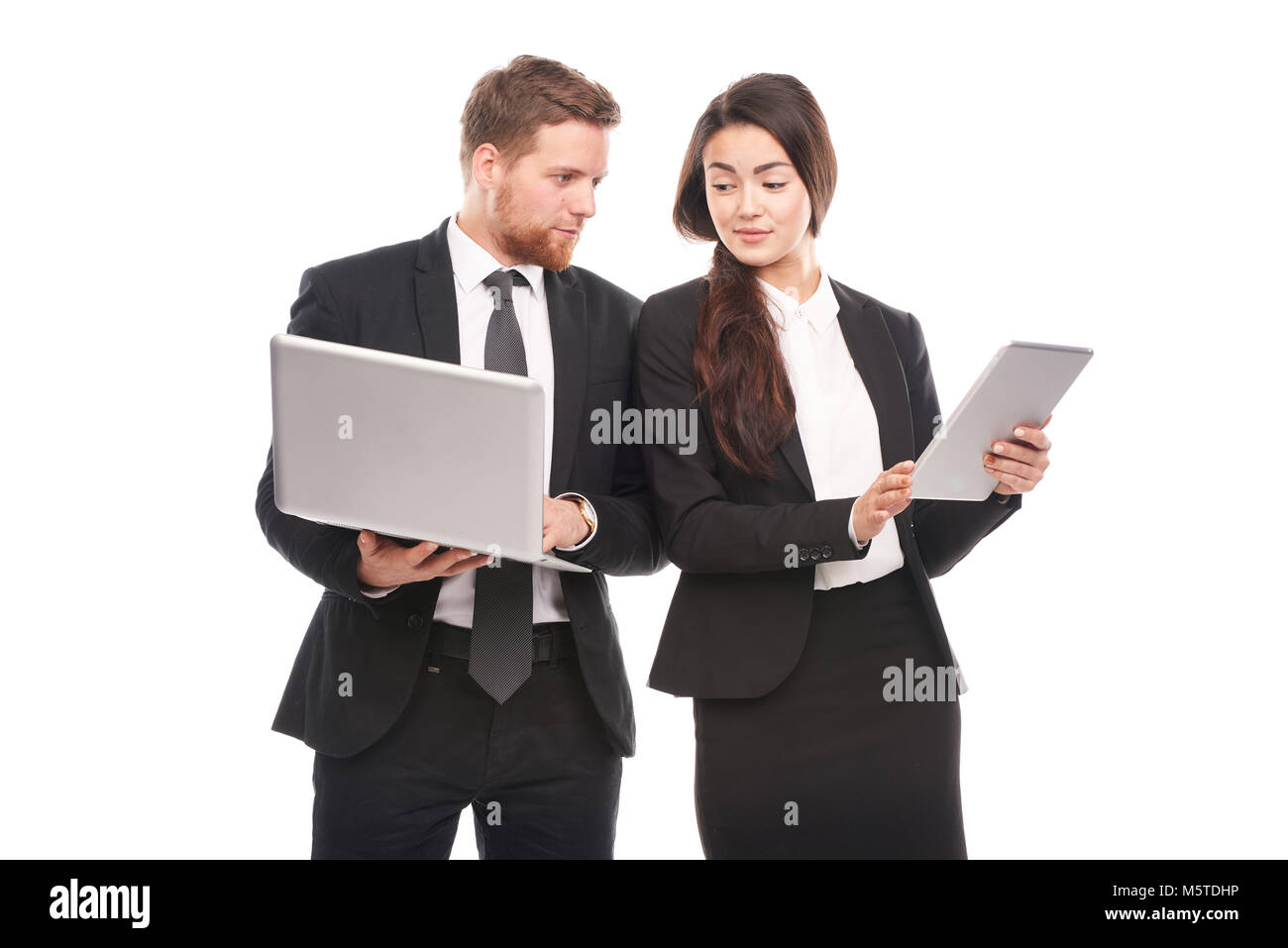 Business partners looking tablet discussing hi-res stock photography ...