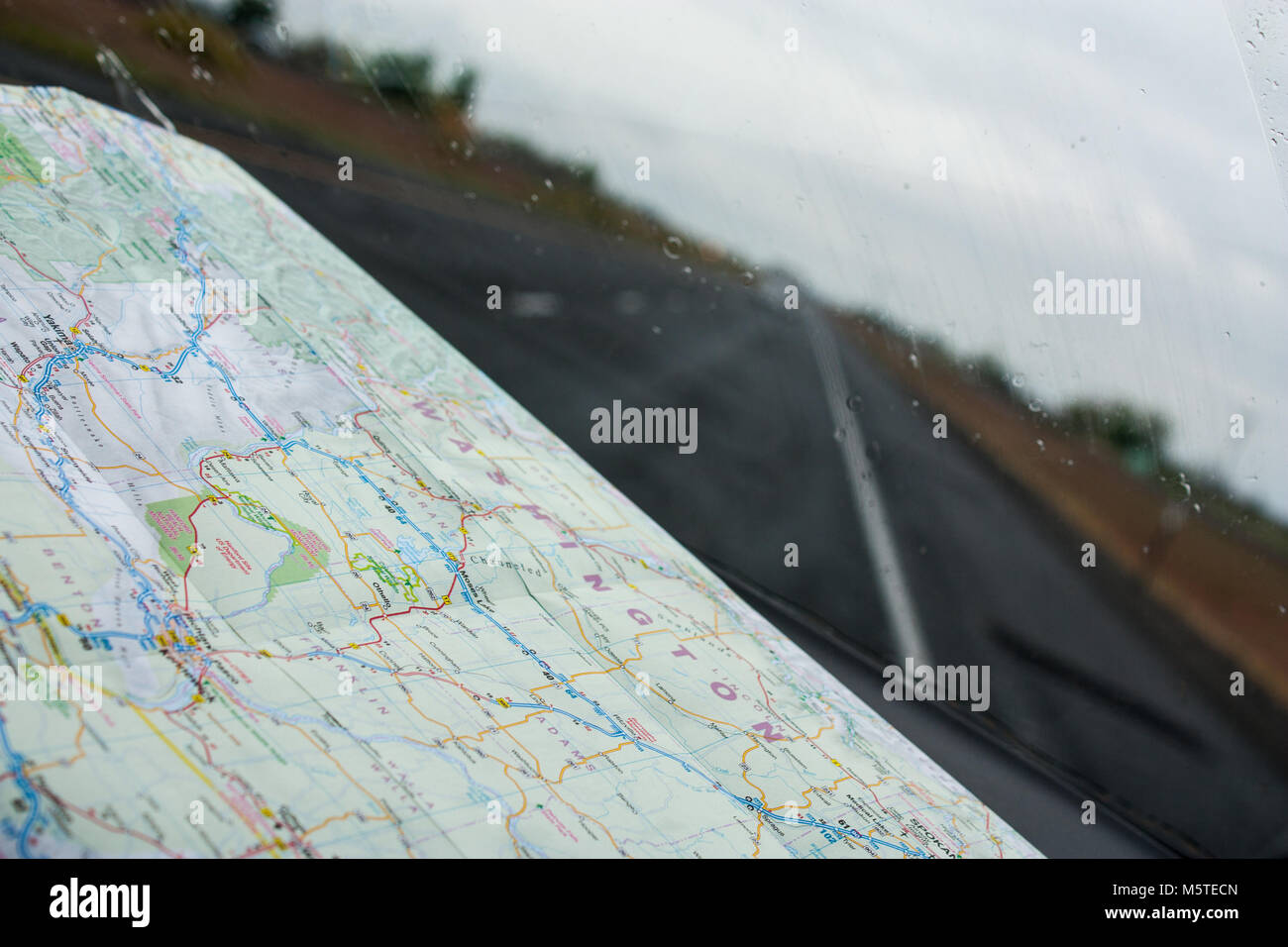 Looking through a windshield with a road map on the dashboard Stock ...