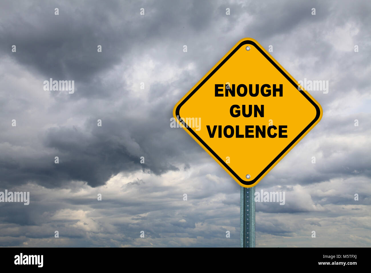 Gun control sign enough gun violence against a cloudy sky Stock Photo ...