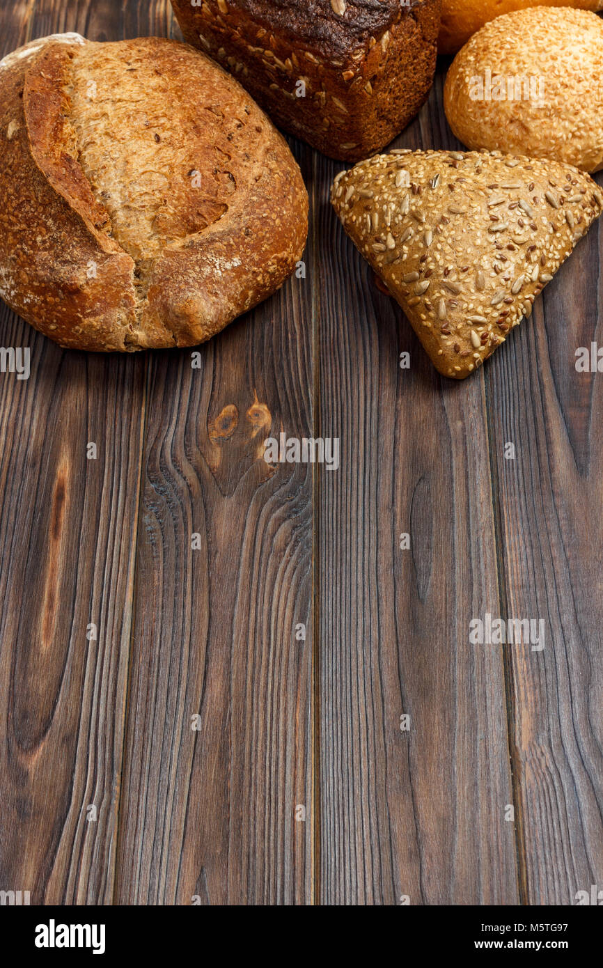 Bakery background, bread assortment on black wooden backdrop. Top view ...