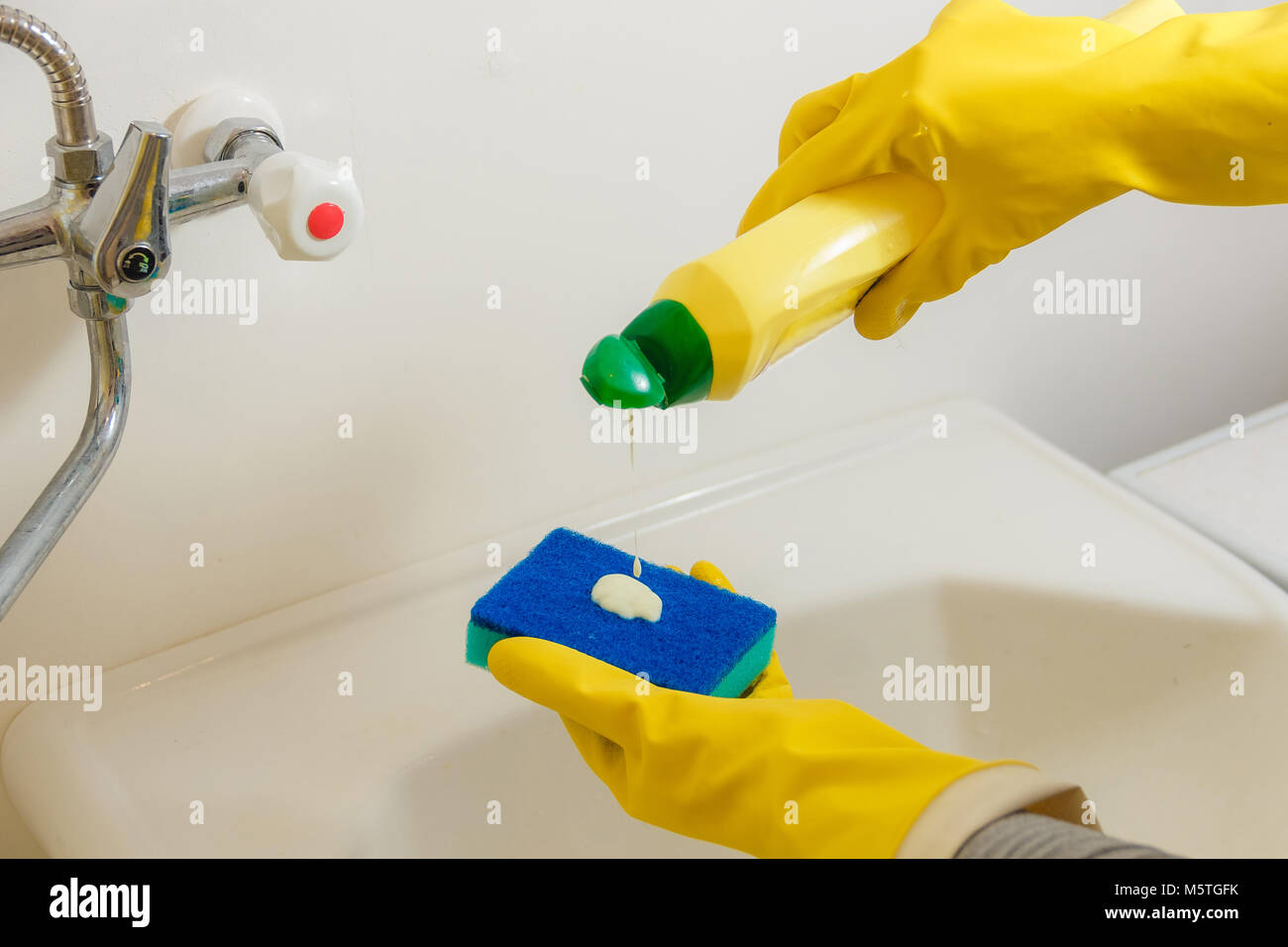 Cleaning kitchen sink yellow sponge hi-res stock photography and images ...