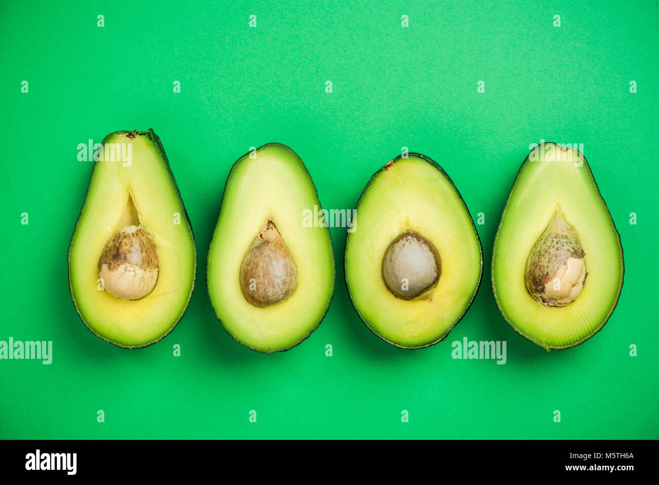 Avocado flat lay on green pastel background. Food concept Stock Photo ...