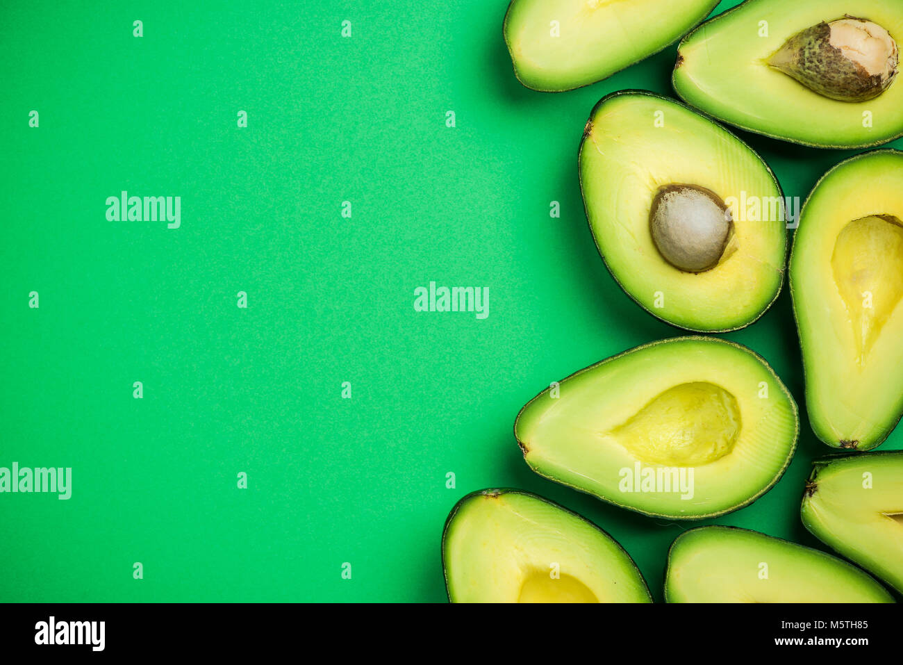 Avocado on pastel background,creative food concept Stock Photo - Alamy