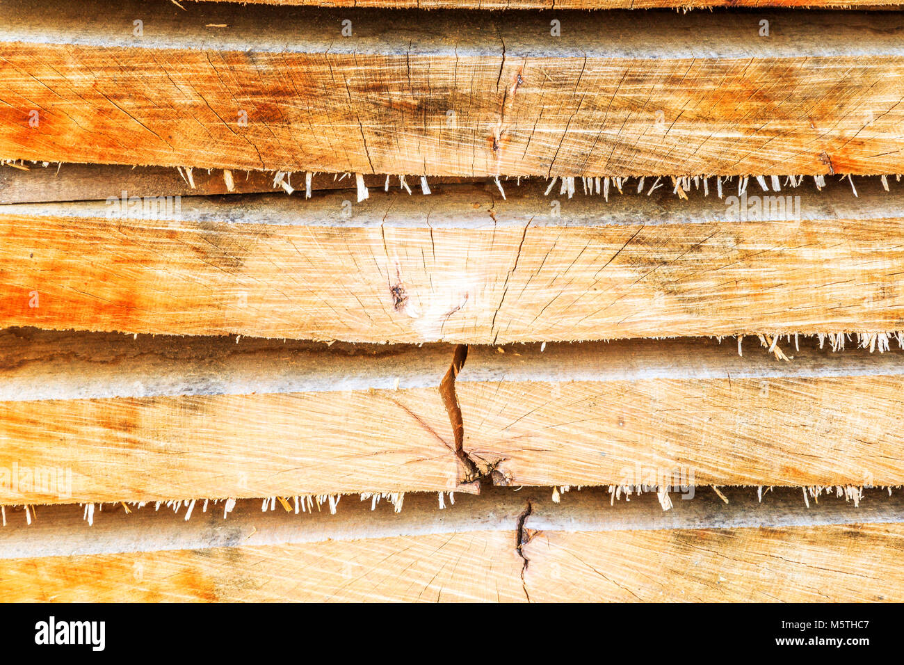 Stacks of timber seasoning in the sun ready for use in historical ...