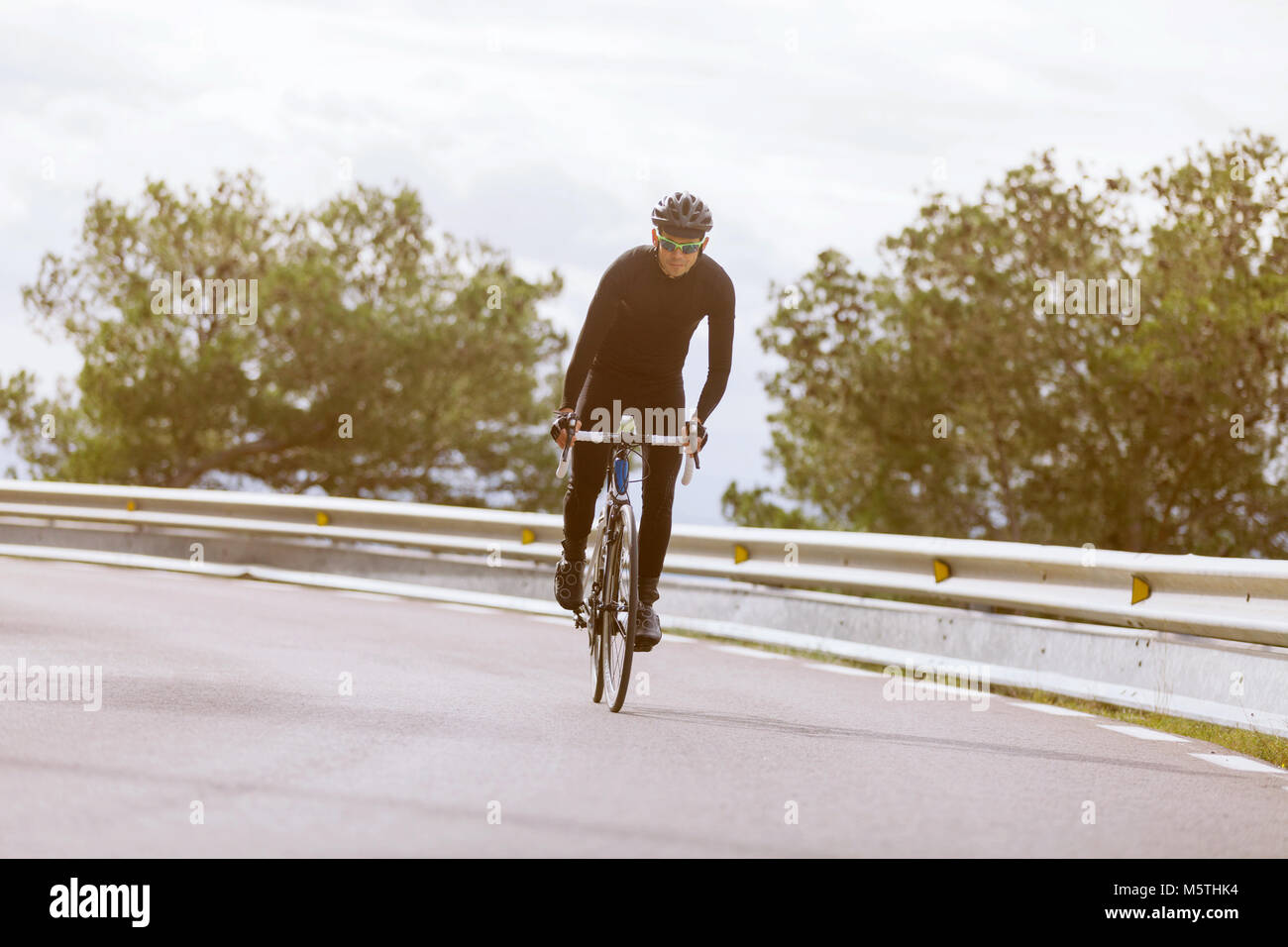 Cyclist riding on country road hi-res stock photography and images - Alamy
