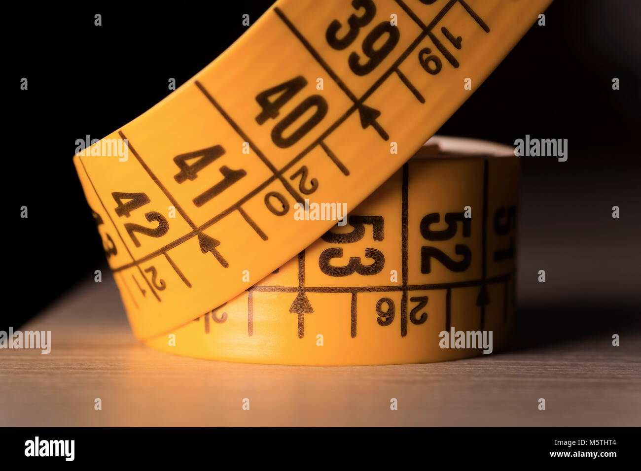 Measuring tape isolated on the table Stock Photo - Alamy