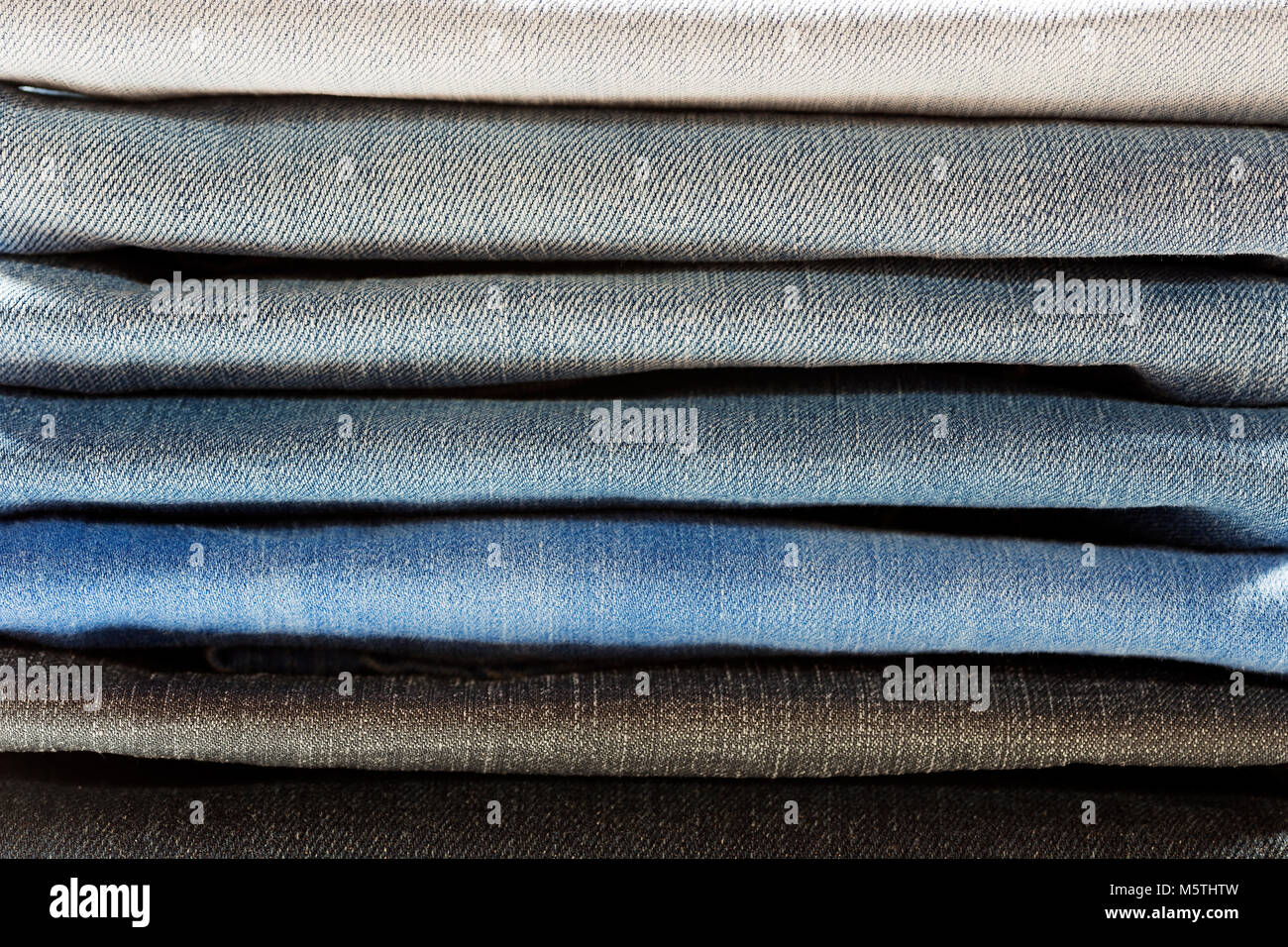 Stack of jeans in different colors Stock Photo - Alamy
