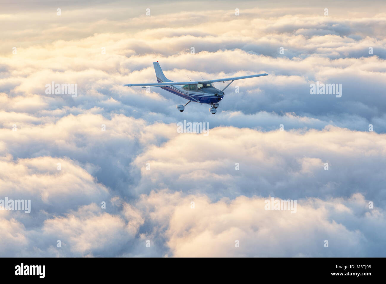 Small single engine airplane flying in the gorgeous sunset sky ...