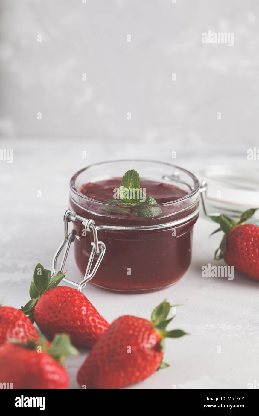 Strawberry jam in a glass jar, gray background Stock Photo - Alamy