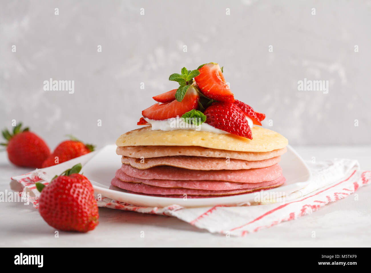 Stack of pink ombre pancakes with strawberry. Breakfast background ...