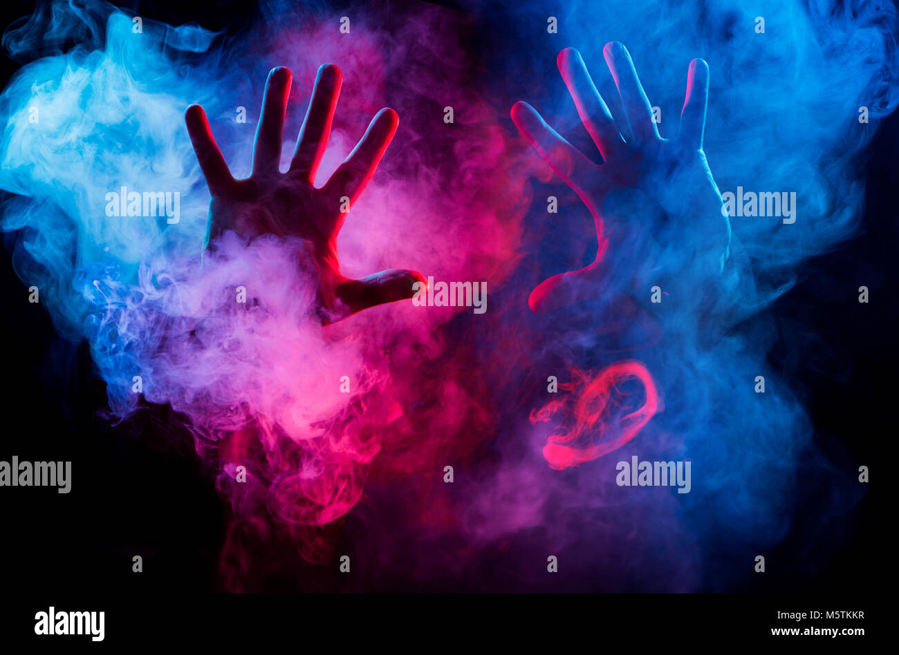 hands inside colorful smoke on black background Stock Photo - Alamy