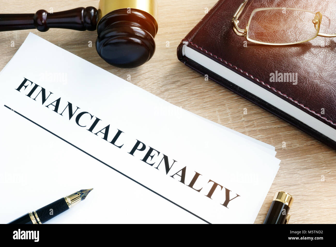 Document with title Financial penalty on a desk Stock Photo - Alamy
