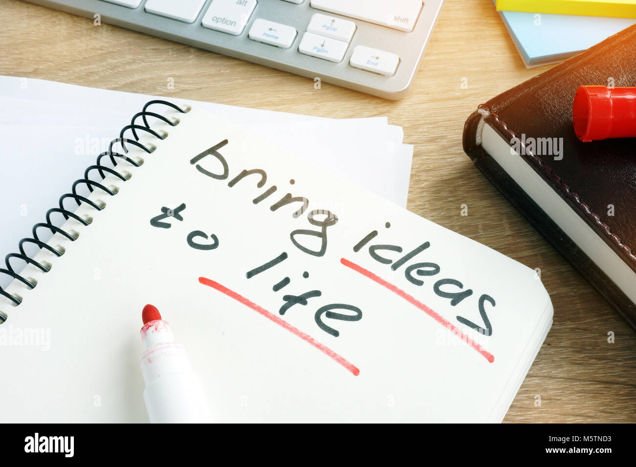 Bring ideas to life written in a note Stock Photo - Alamy