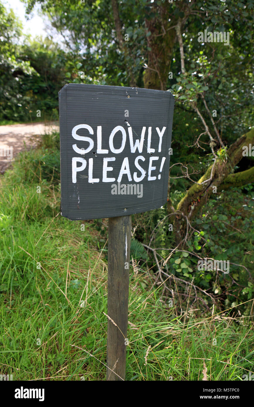 Slowly please sign on a country lane Stock Photo - Alamy