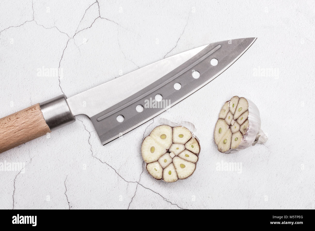 Macro closeup of a freshly cut garlic bulb with a knife Stock Photo - Alamy