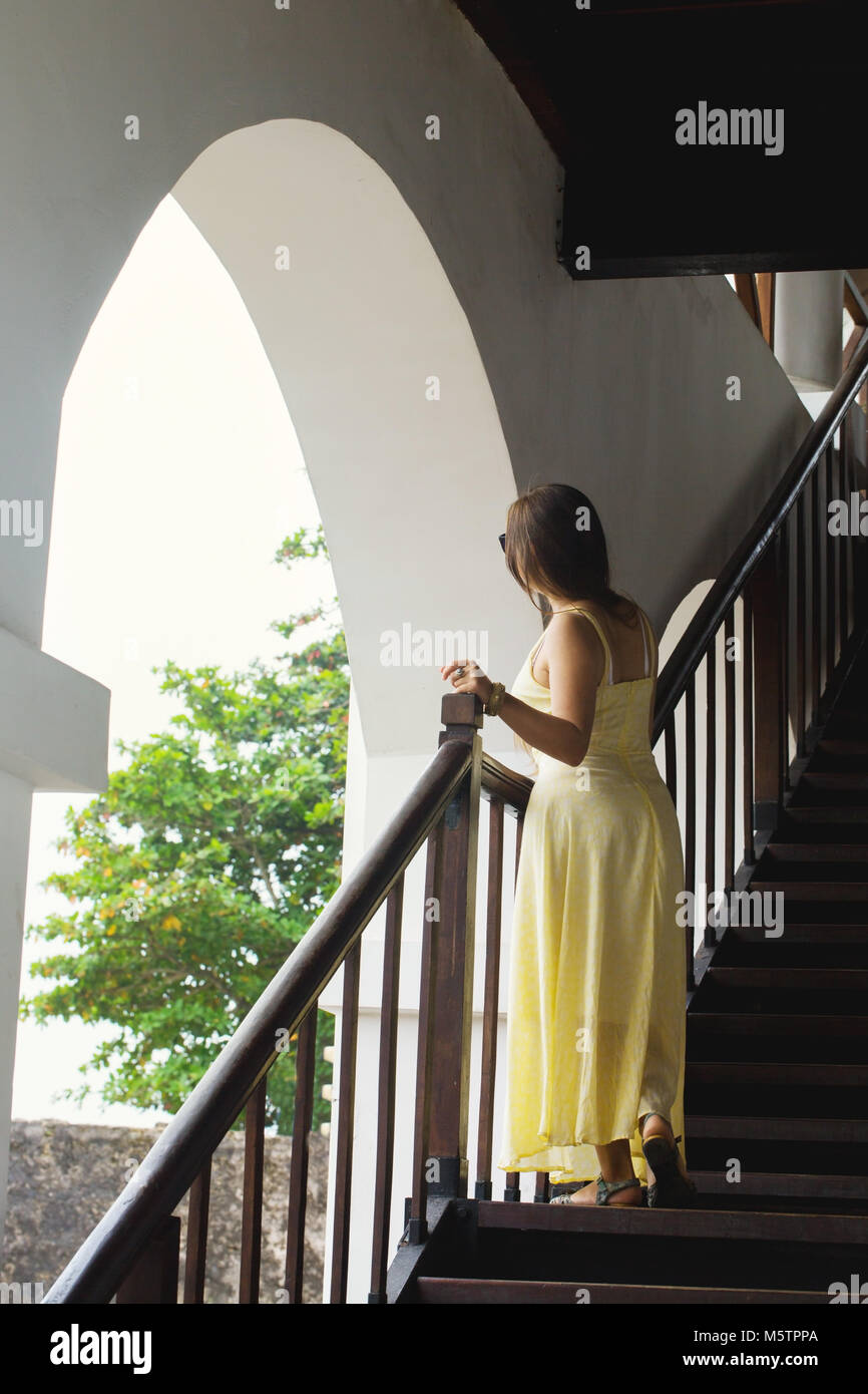 A woman standing on staircase Stock Photo - Alamy