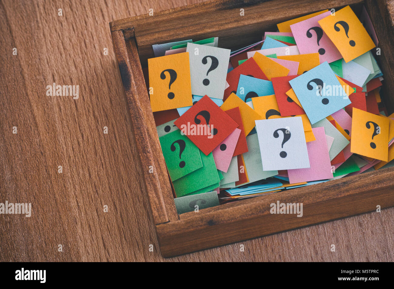 Question marks in a wooden box. Close up Stock Photo - Alamy