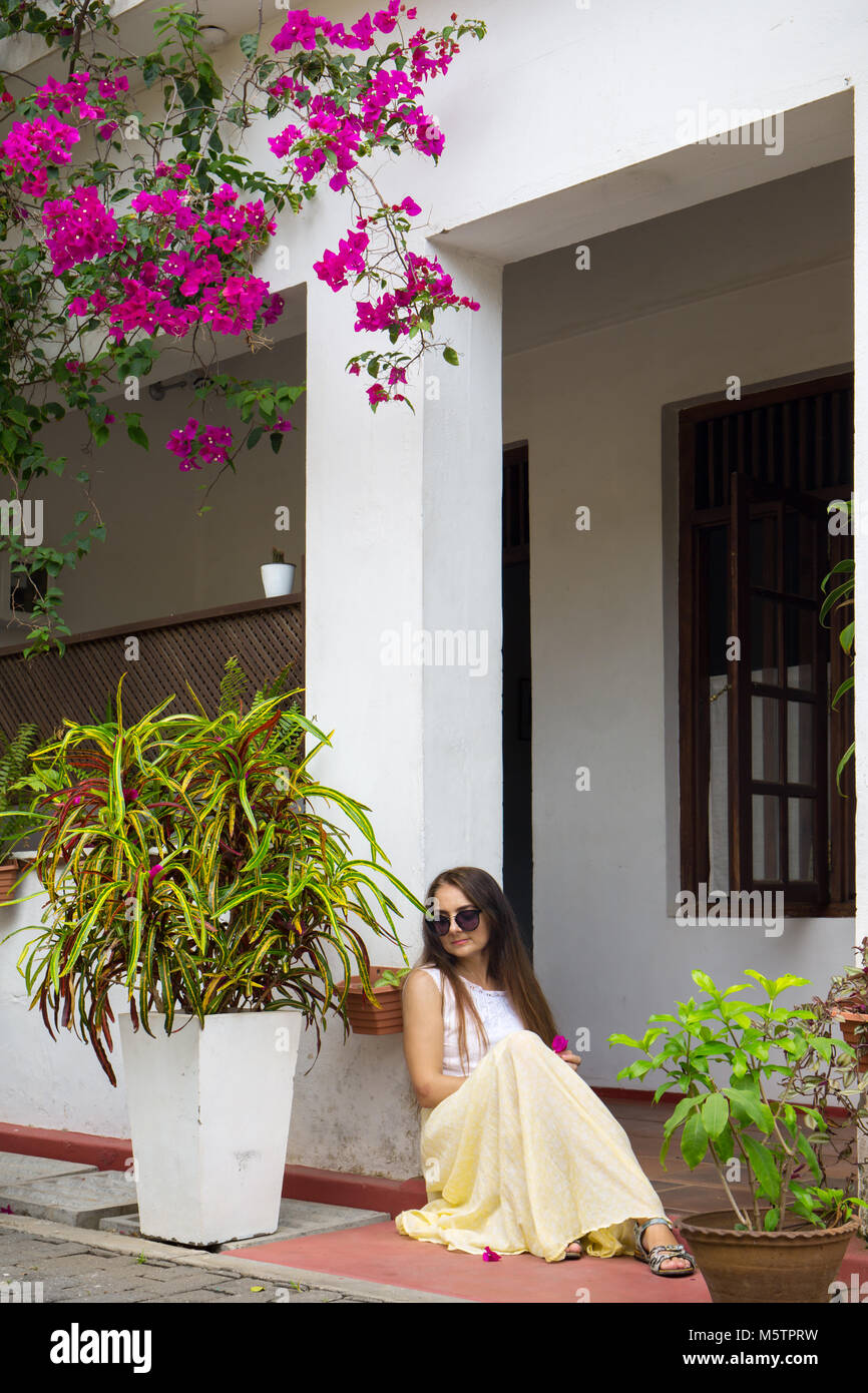 A woman is sitting on the doorstep Stock Photo - Alamy