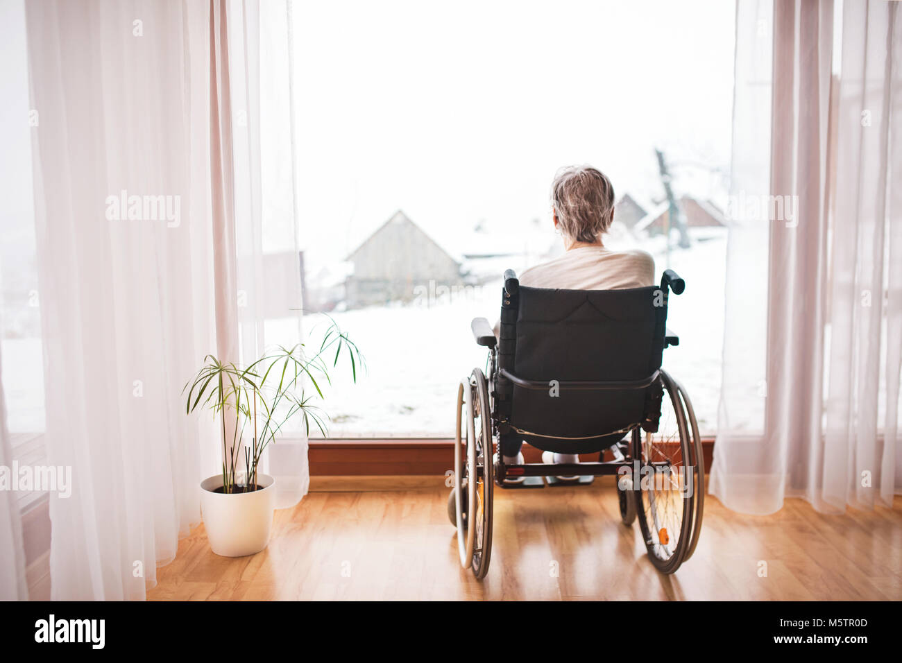Senior woman in wheelchair at home Stock Photo - Alamy