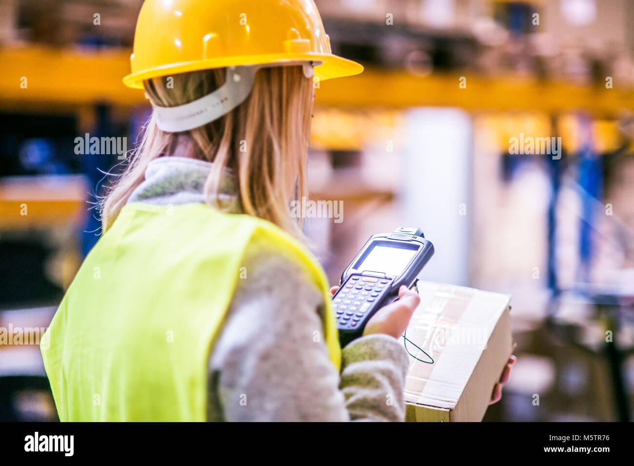 Warehouse woman worker with barcode scanner Stock Photo - Alamy