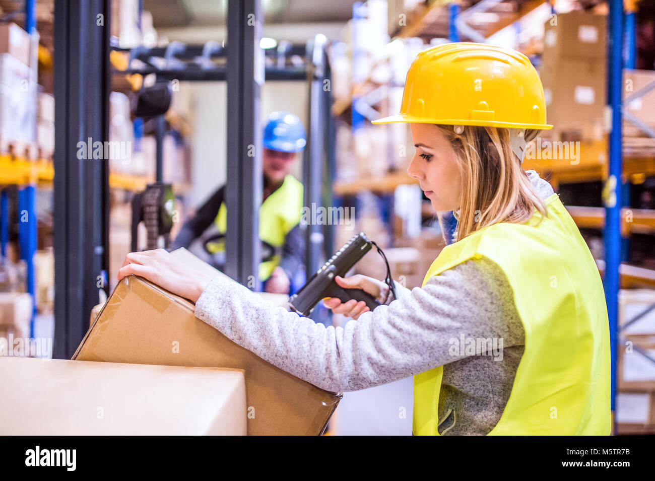 Warehouse woman worker with barcode scanner Stock Photo - Alamy