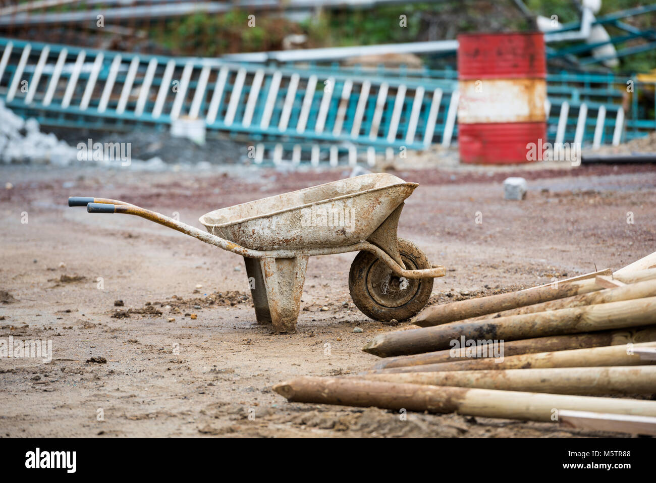 construction site, hand truck, wood piles and pipes Stock Photo - Alamy