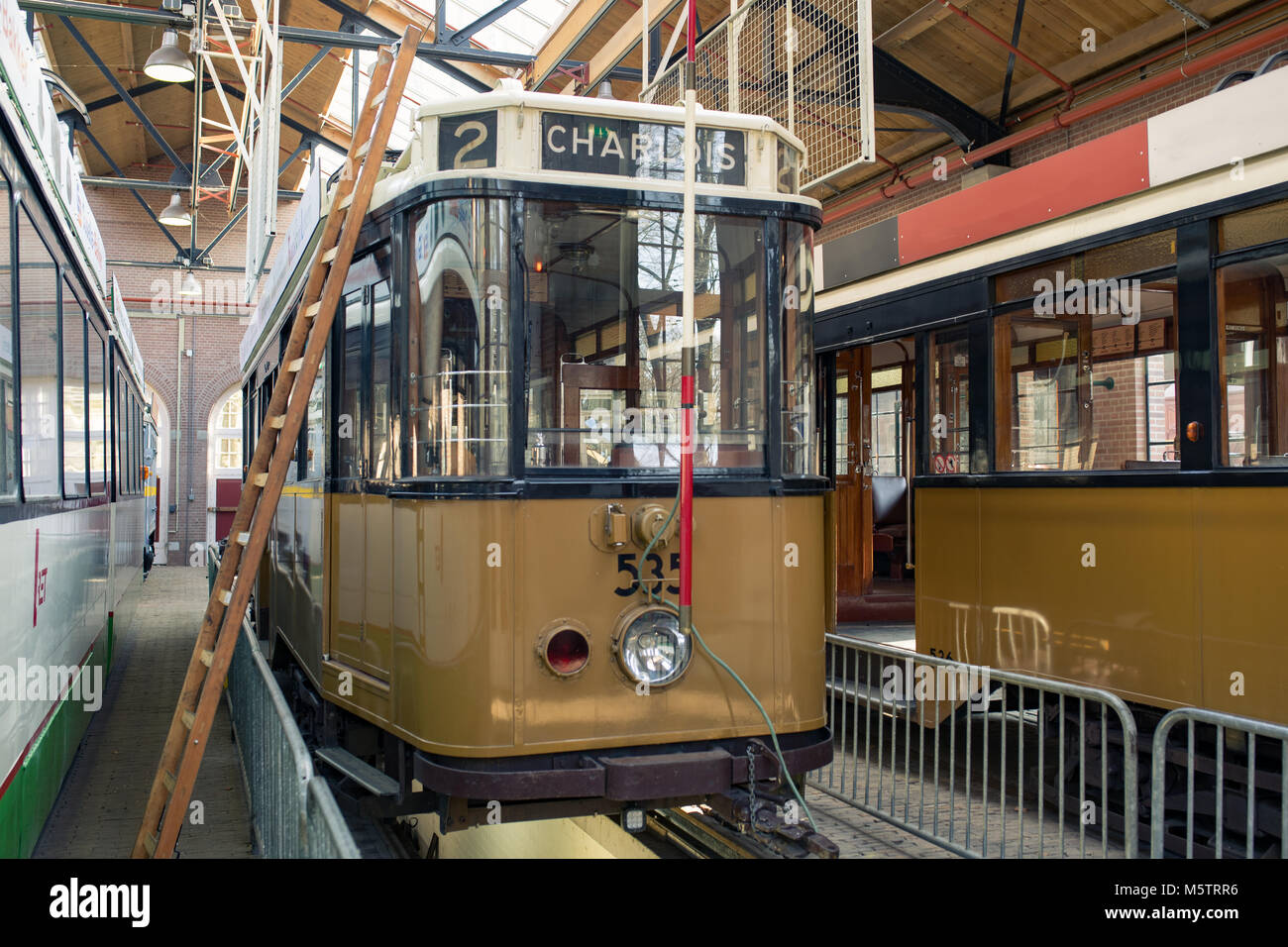 Vintage, retro style trams being serviced at tram depot in the open-air ...