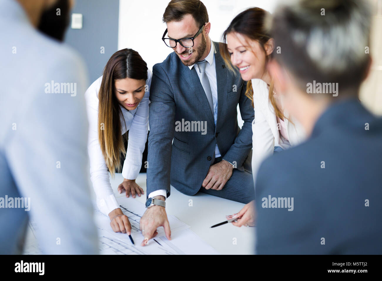 Portrait of architects having discussion in office Stock Photo - Alamy
