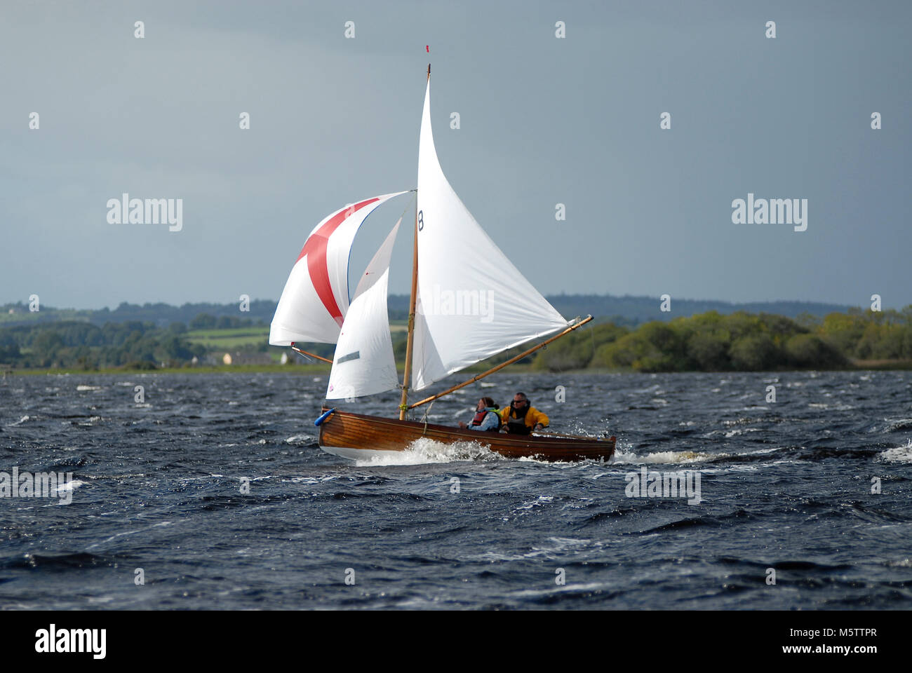 A traditional Water Wag dinghy races down Lough Ree during the Irish ...
