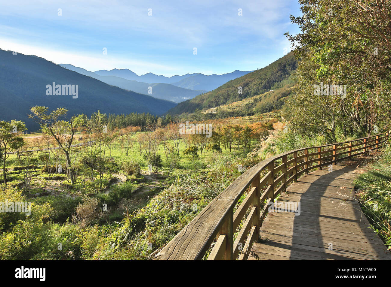 Beautiful mountain landscape with wooden railing and path in a sunny ...