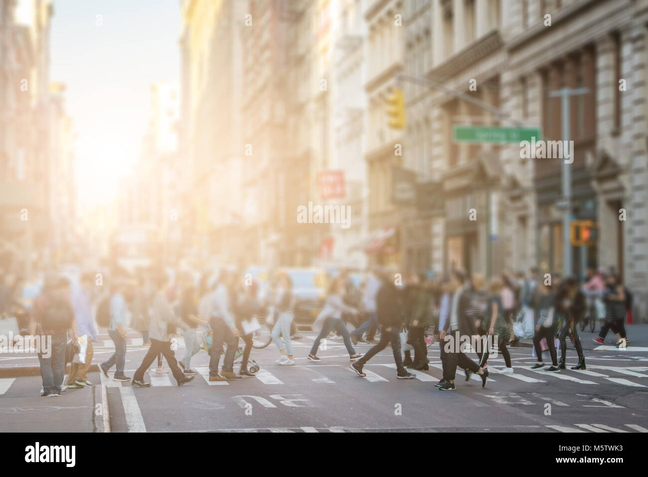 Anonymous crowd of people walking across the intersection in SoHo New ...