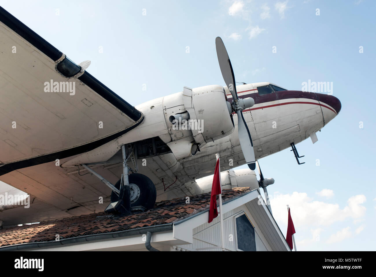 An airplane on the roof of a building Stock Photo - Alamy