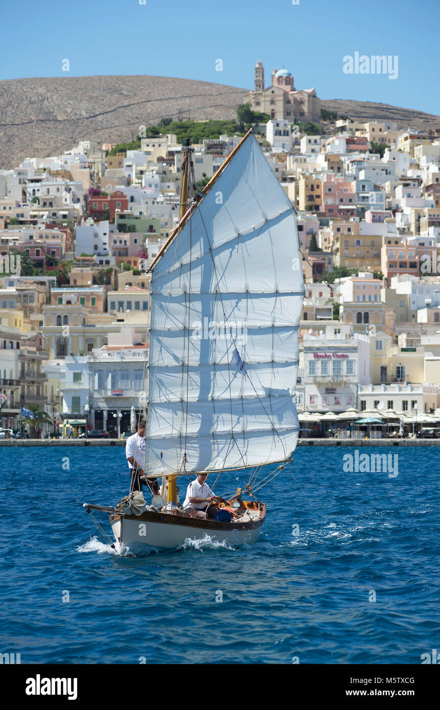 The sailing boat Chryssopigi sails out of Syros harbour, in Greece. The ...