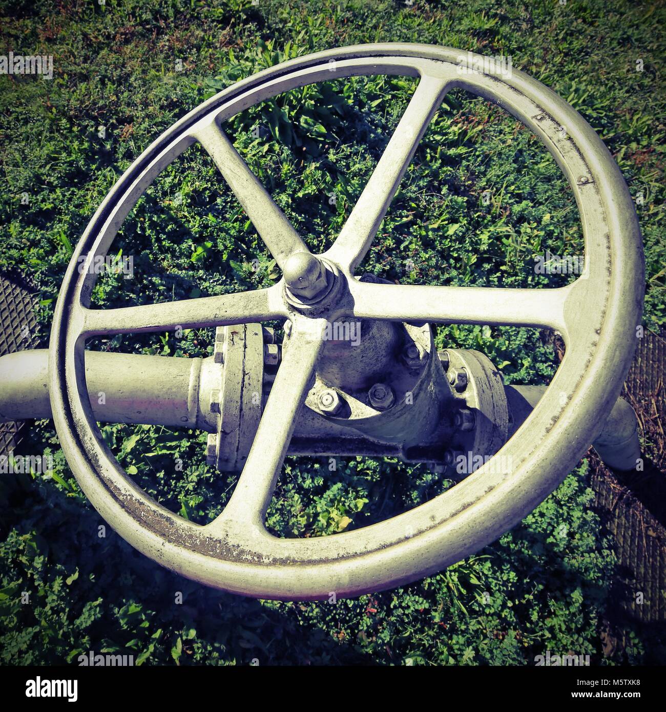 gate valve to close pipeline with vintage effect Stock Photo - Alamy