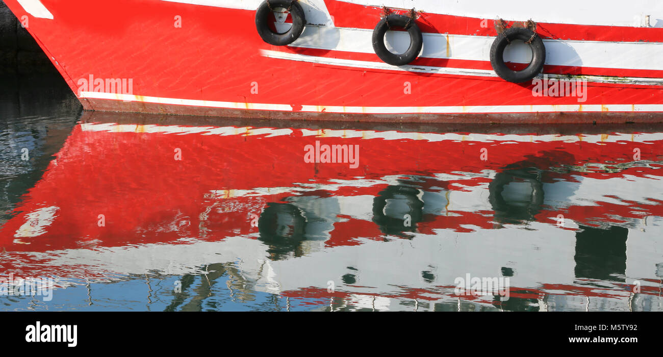 detail of a big red and white ship reflected on the sea water Stock ...