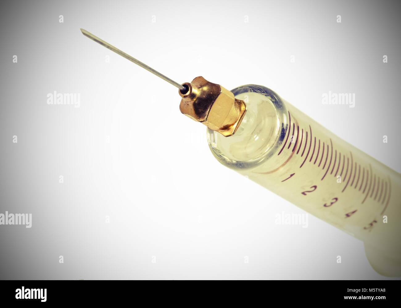 detail of the needle for injections of a glass medical syringe on a ...