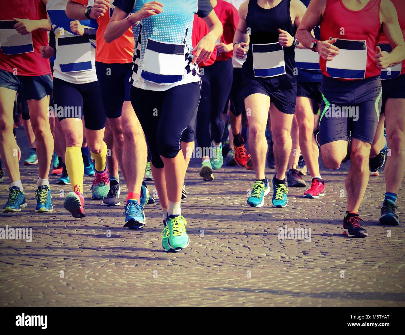 many runners on the finish line of an marathon race with vintage ...