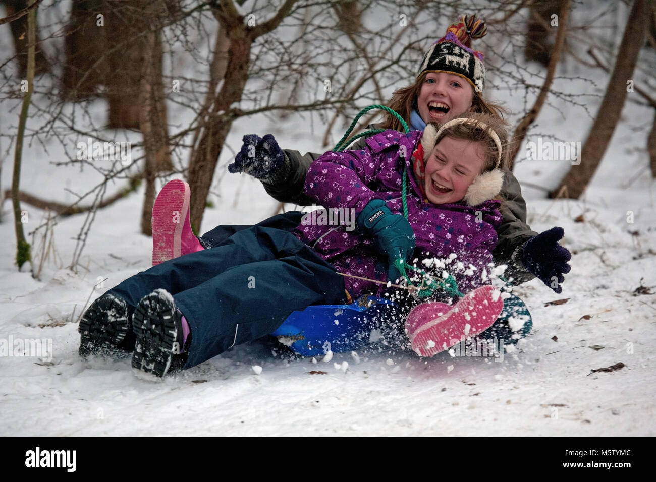 Boy and girl sledging hi-res stock photography and images - Alamy