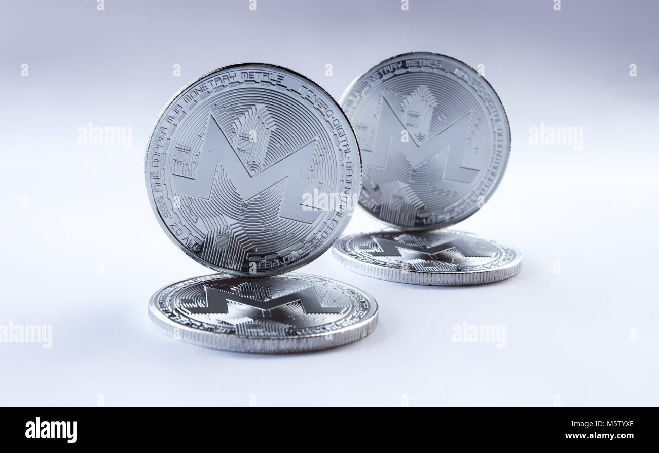 On a gray background are silver coins of a digital crypto currency ...