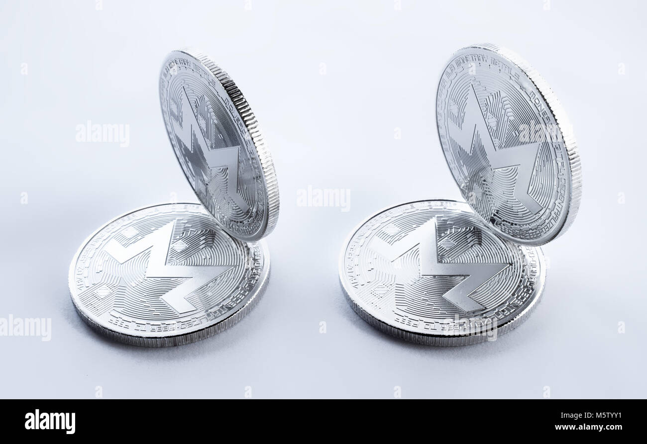 On a white background are silver coins of a digital crypto currency ...