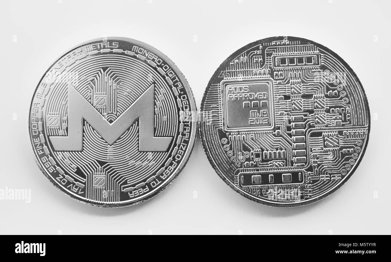 On a white background are silver coins of a digital crypto currency ...