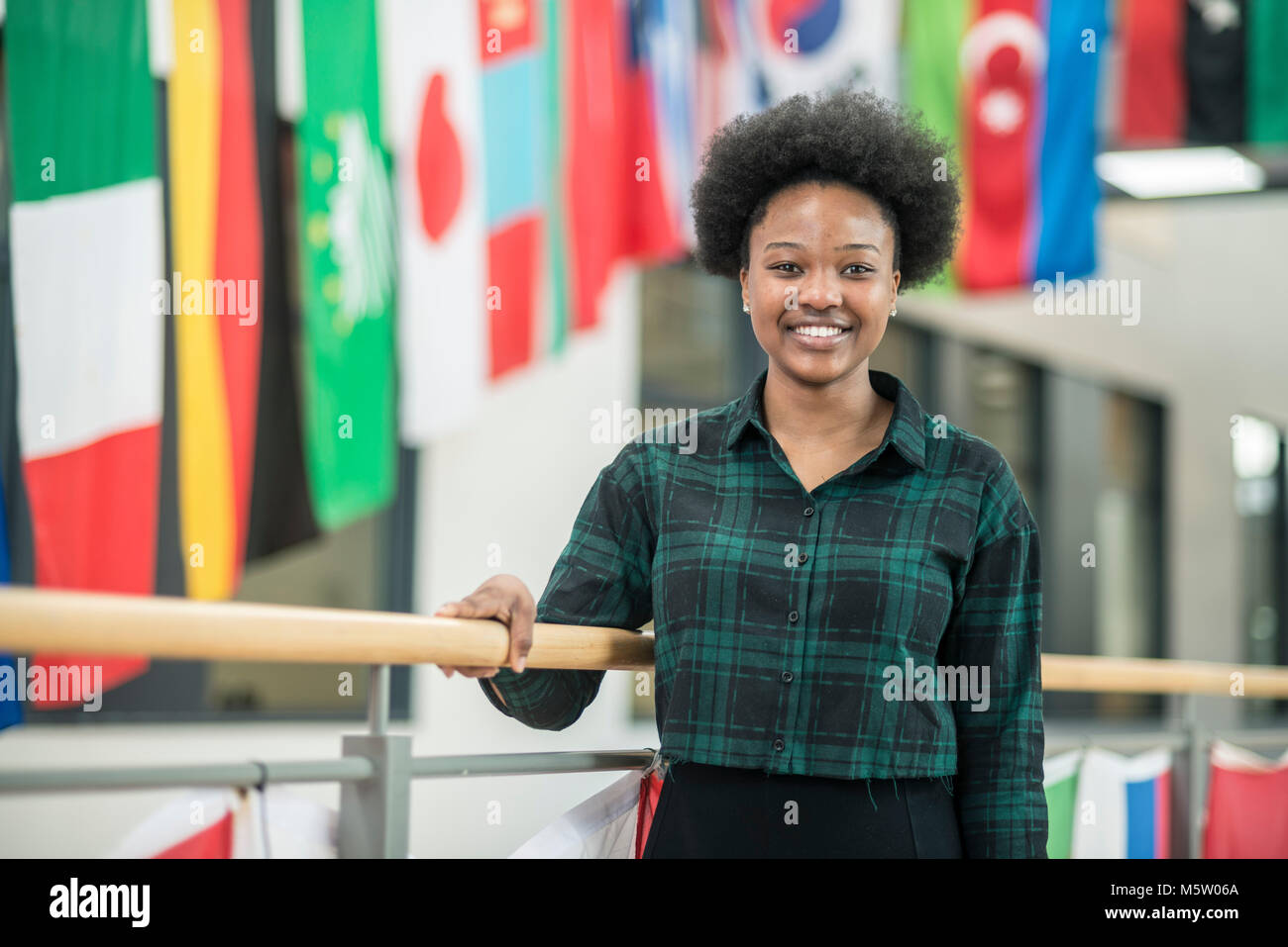 a young black student has her portrait taken in the college hallway ...