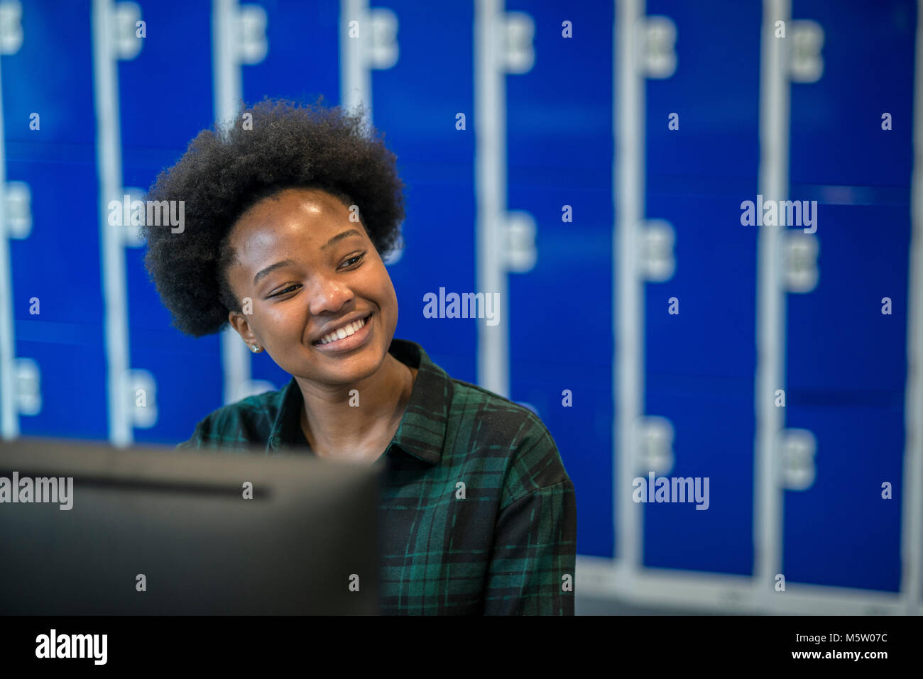 a young black international student is photographed using a computer in ...