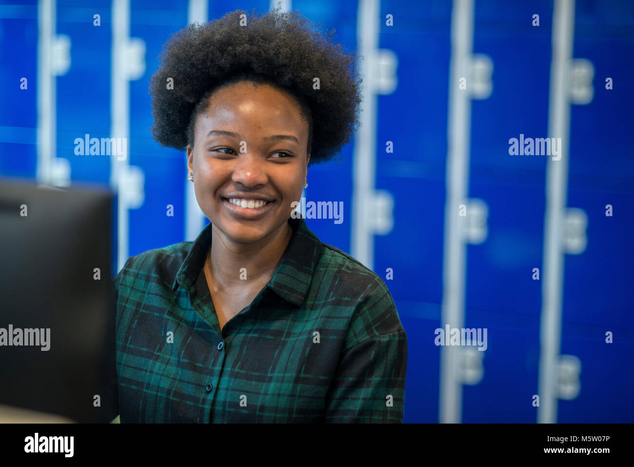 a young black international student is photographed using a computer in ...