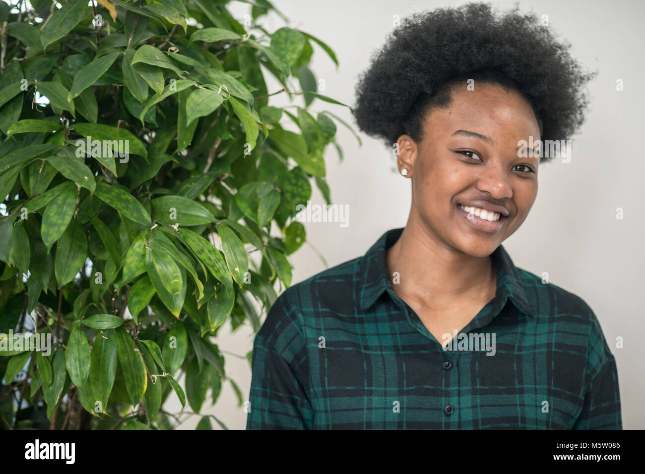 a young black student has her portrait taken in the college hallway ...